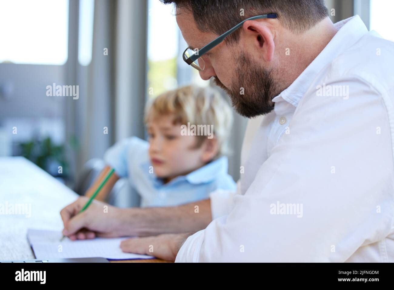 Father checking sons homework hi-res stock photography and images - Alamy