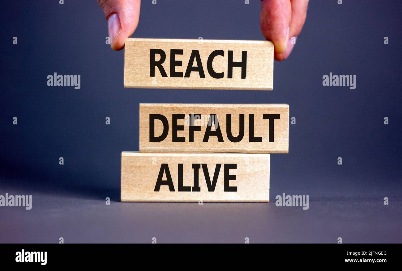 Reach default alive symbol. Concept words Reach default alive on wooden ...