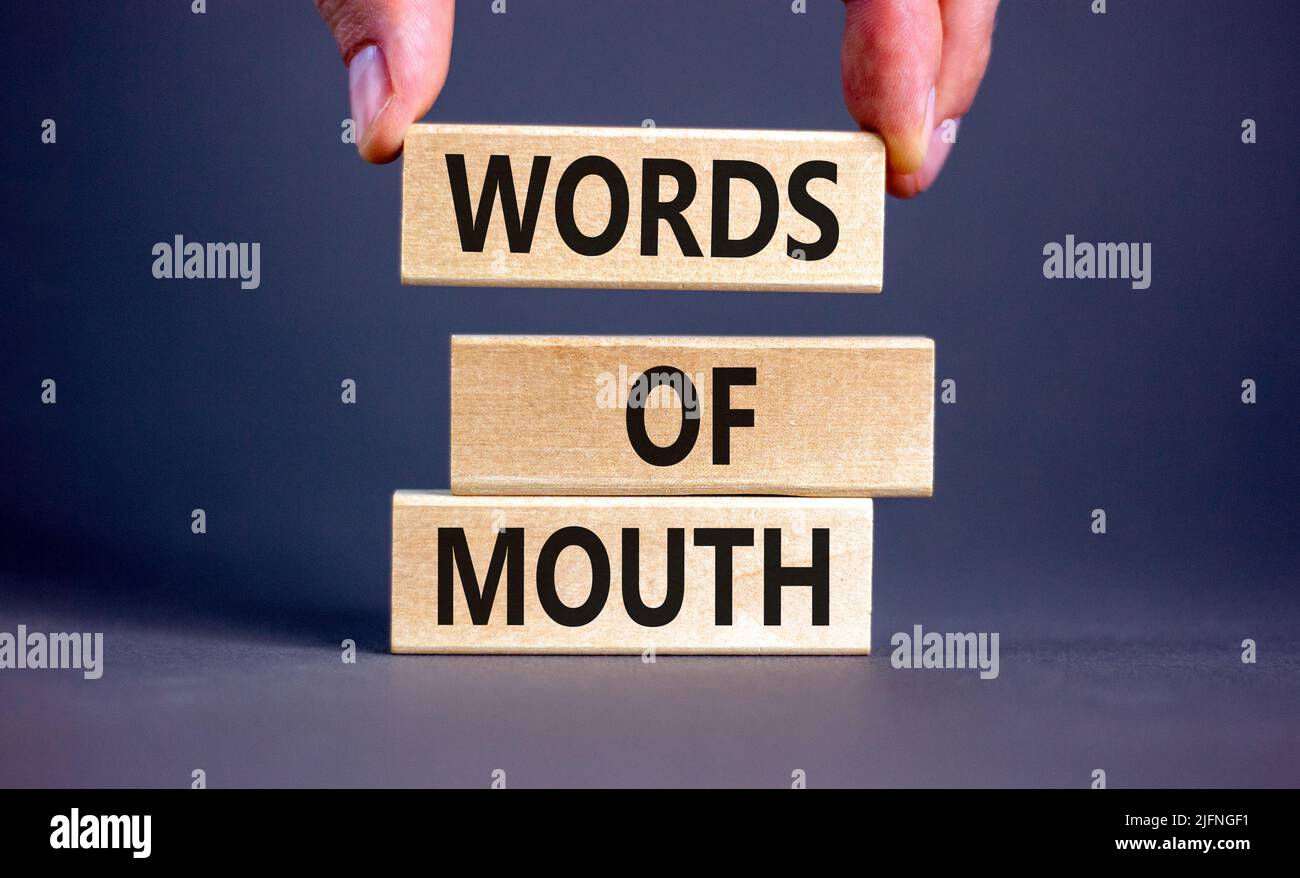 Words of mouth symbol. Concept words Words of mouth on wooden blocks on ...