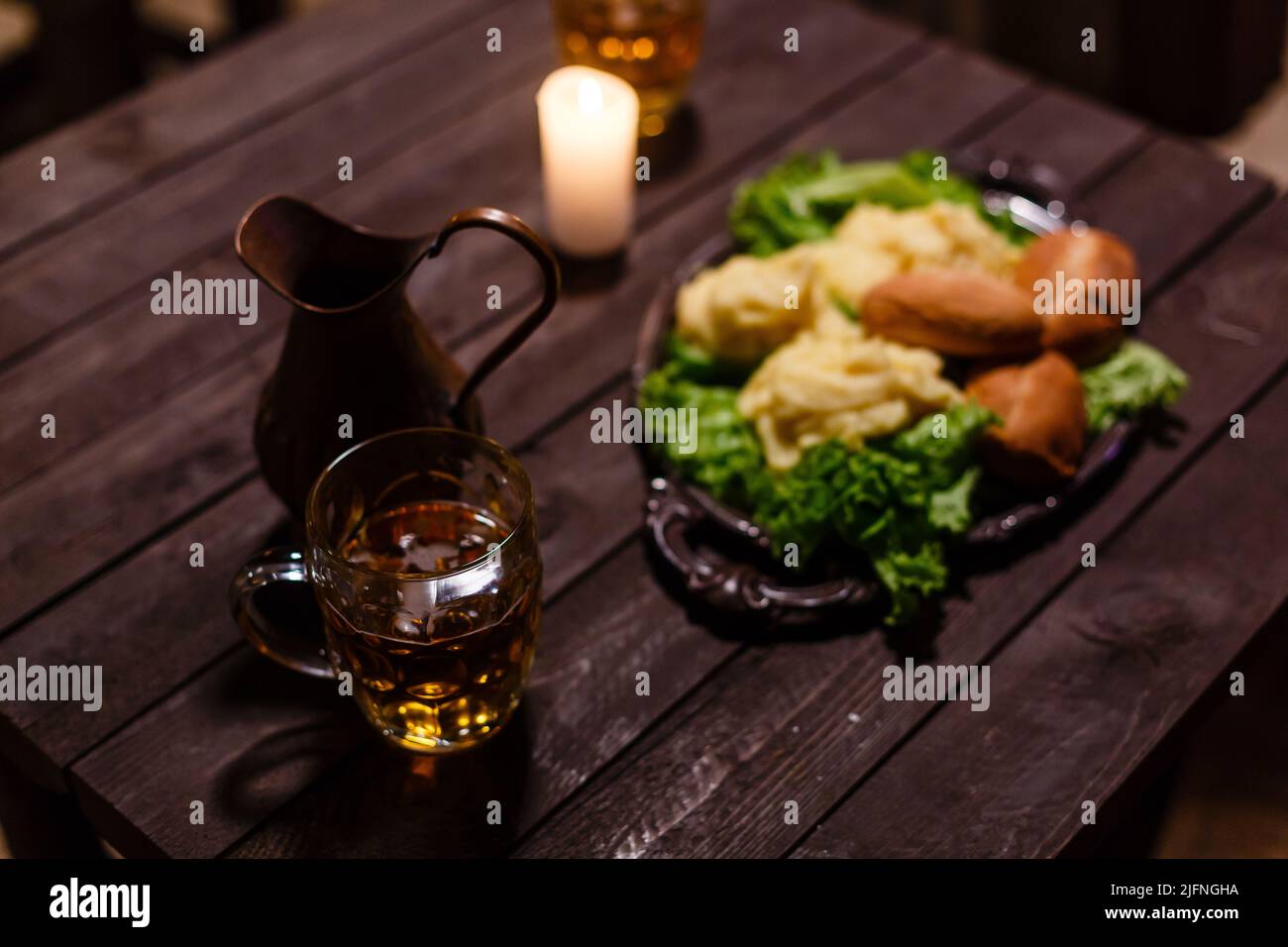 Lanterns on table with beer. candlesticks and beer on a wooden old ...