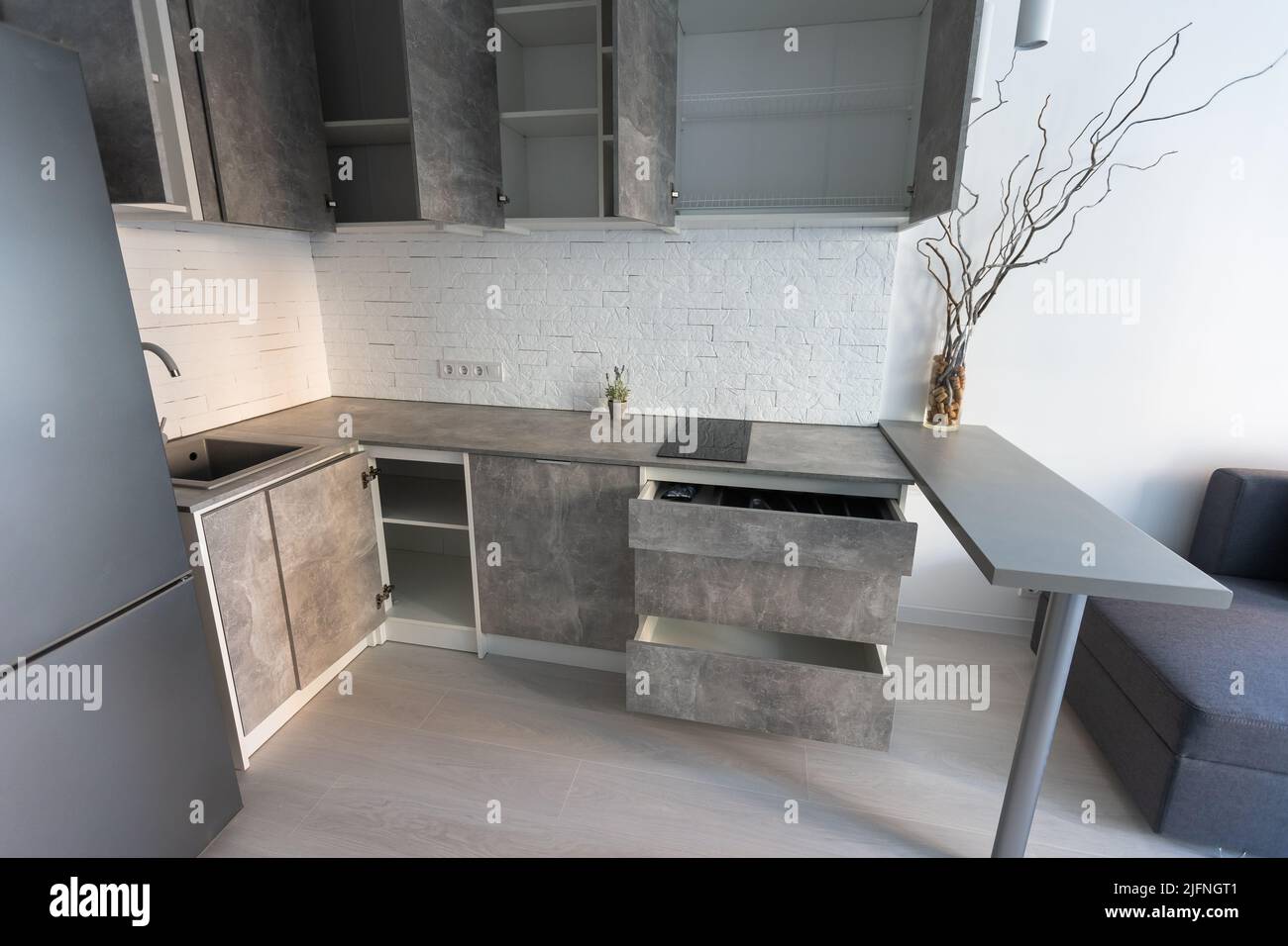installation of a gray loft kitchen, studio apartment Stock Photo - Alamy