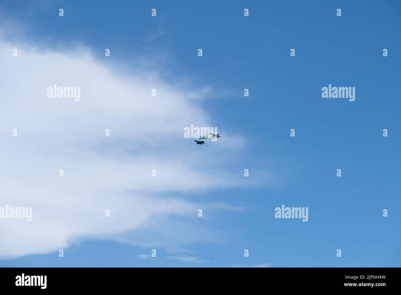 The jets flying against the blue sky and a white cloud Stock Photo - Alamy