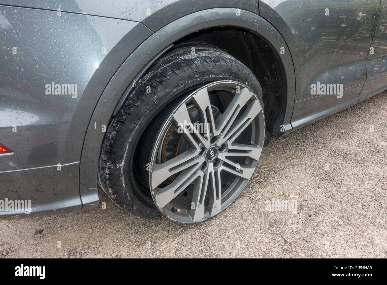 Car with tyre completely off the rim, probably after being stolen ...