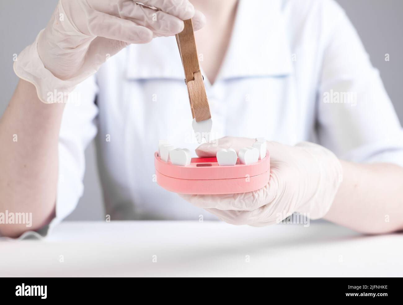 Dentist pulling tooth hi-res stock photography and images - Alamy