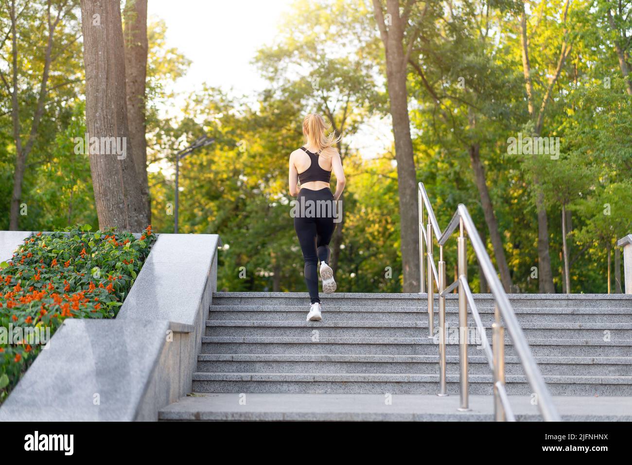 Sport and Fitness. Fit Woman Running up stairs Summer Sunny Morning ...