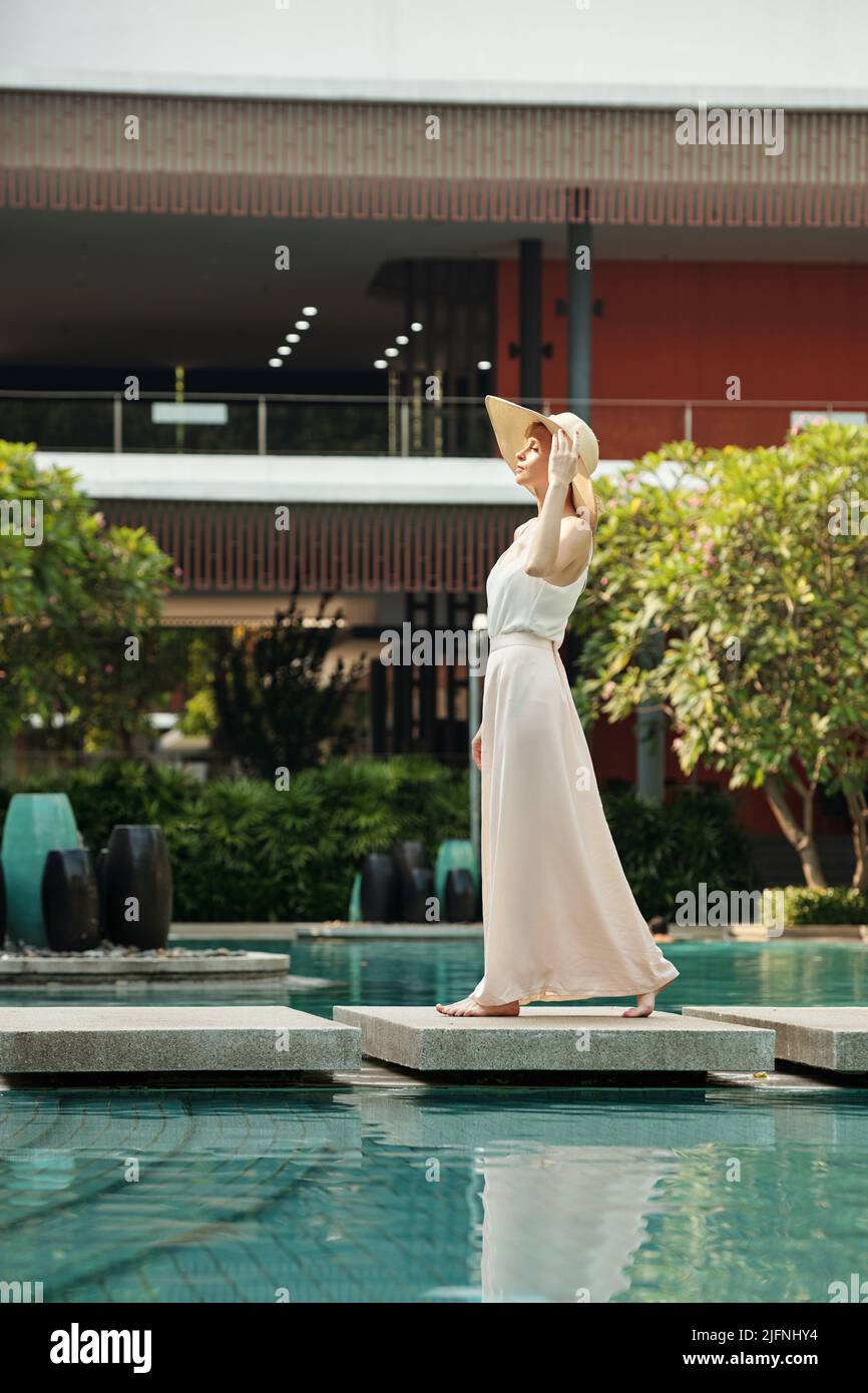 Vertical side view long shot of young adult Caucasian woman enjoying ...