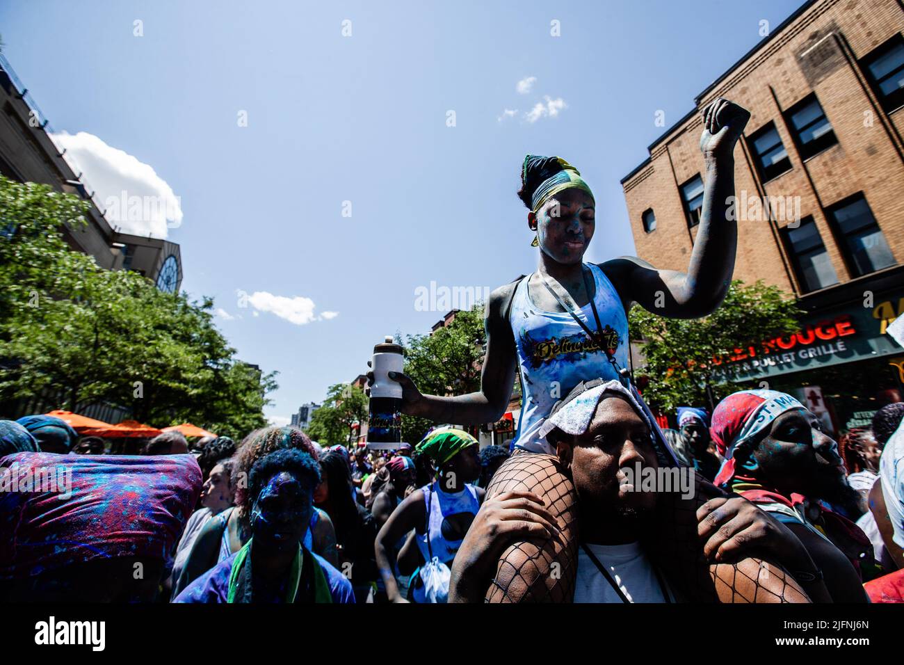 Revellers follow the main float during the parade Stock Photo - Alamy