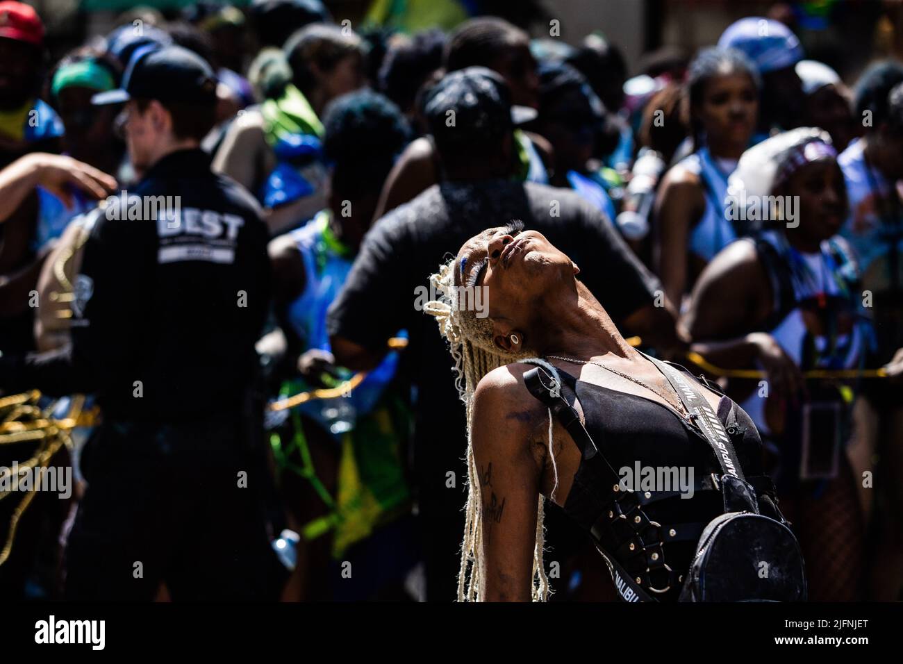 A reveler is dancing near the security belt during the parade Stock ...