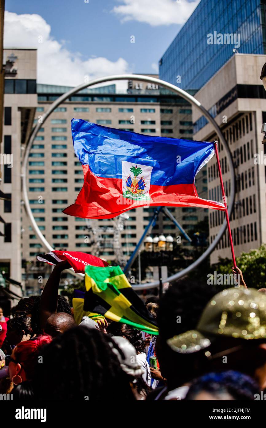 Revelers are waving flags while following the main float in front of ...