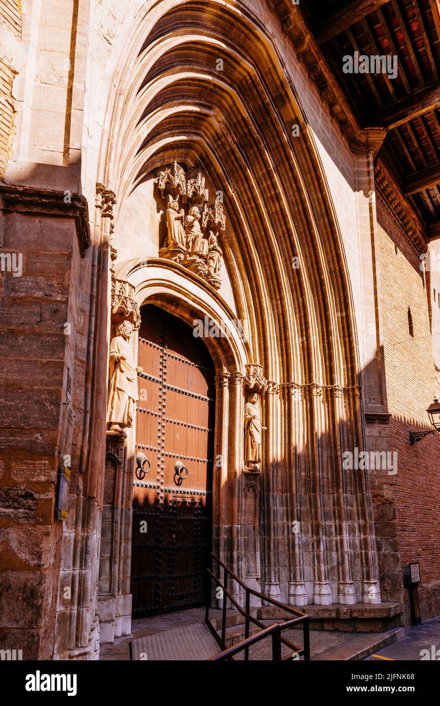 The entrance portal is Gothic in style with a peaked arch flanked by ...
