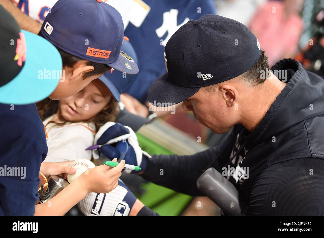 New York Yankees center fielder Aaron Judge (99) signs a fanÕs jersey ...
