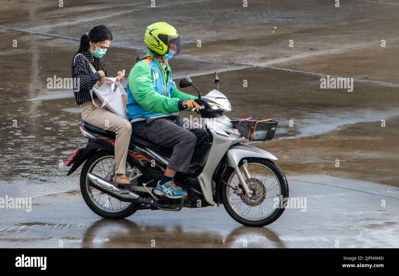 SAMUT PRAKAN, THAILAND, MAR 28 2022, A motorcycle taxi driver with ...