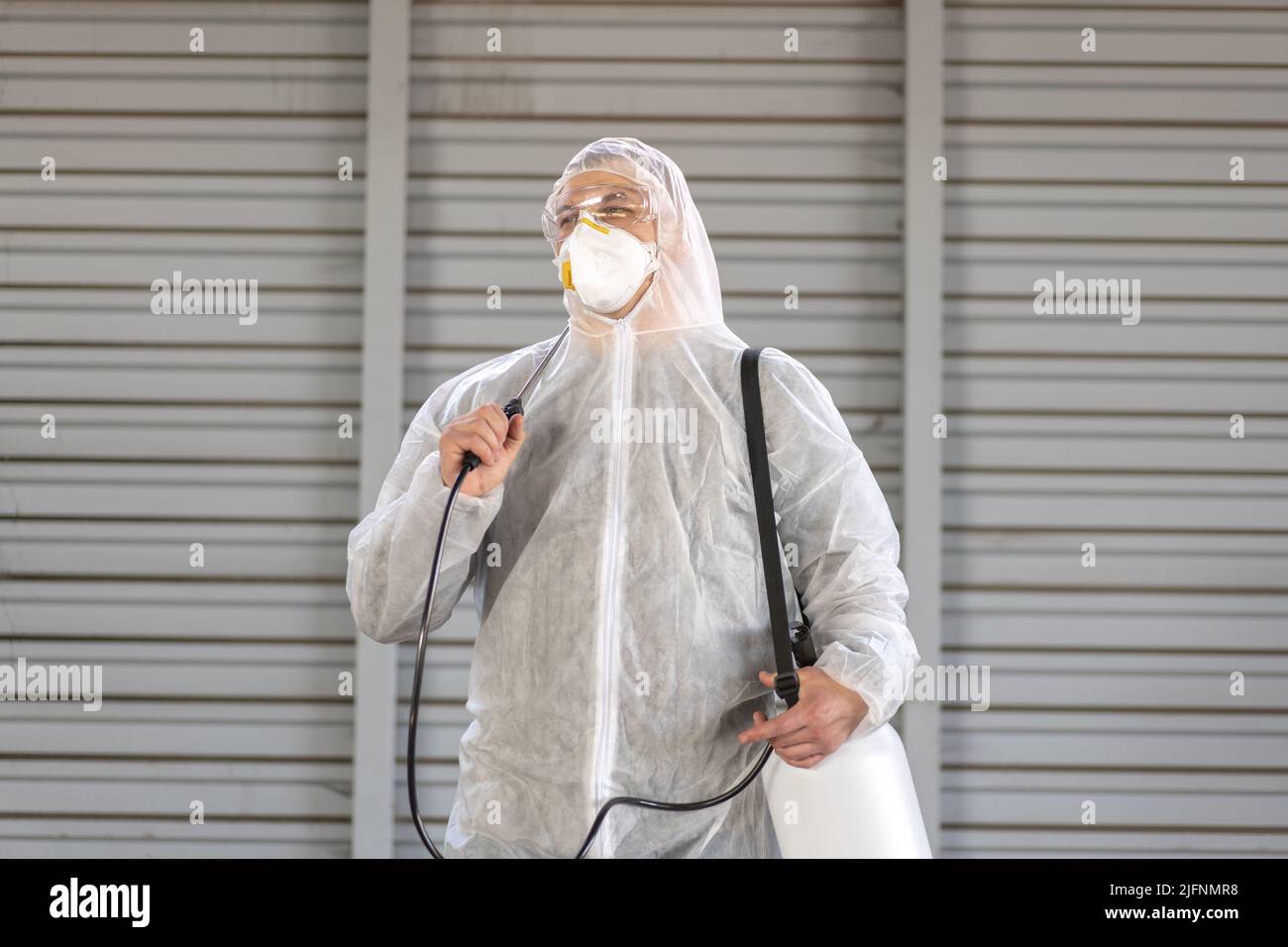Worker wearing protective suit disinfection gear disinfect surface ...