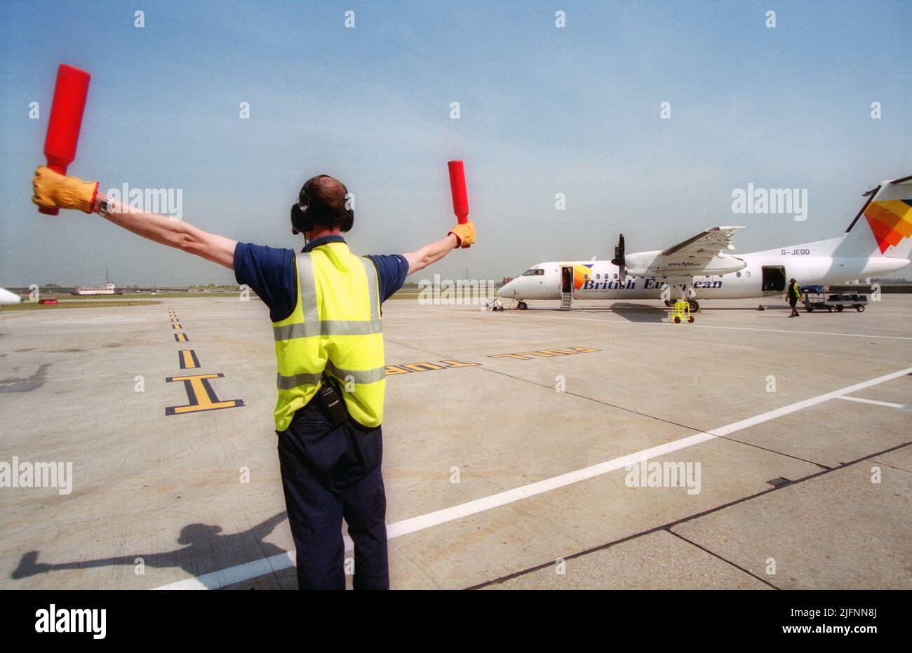 London City Airport aircraft marshal guiding airplane to the gate Stock ...