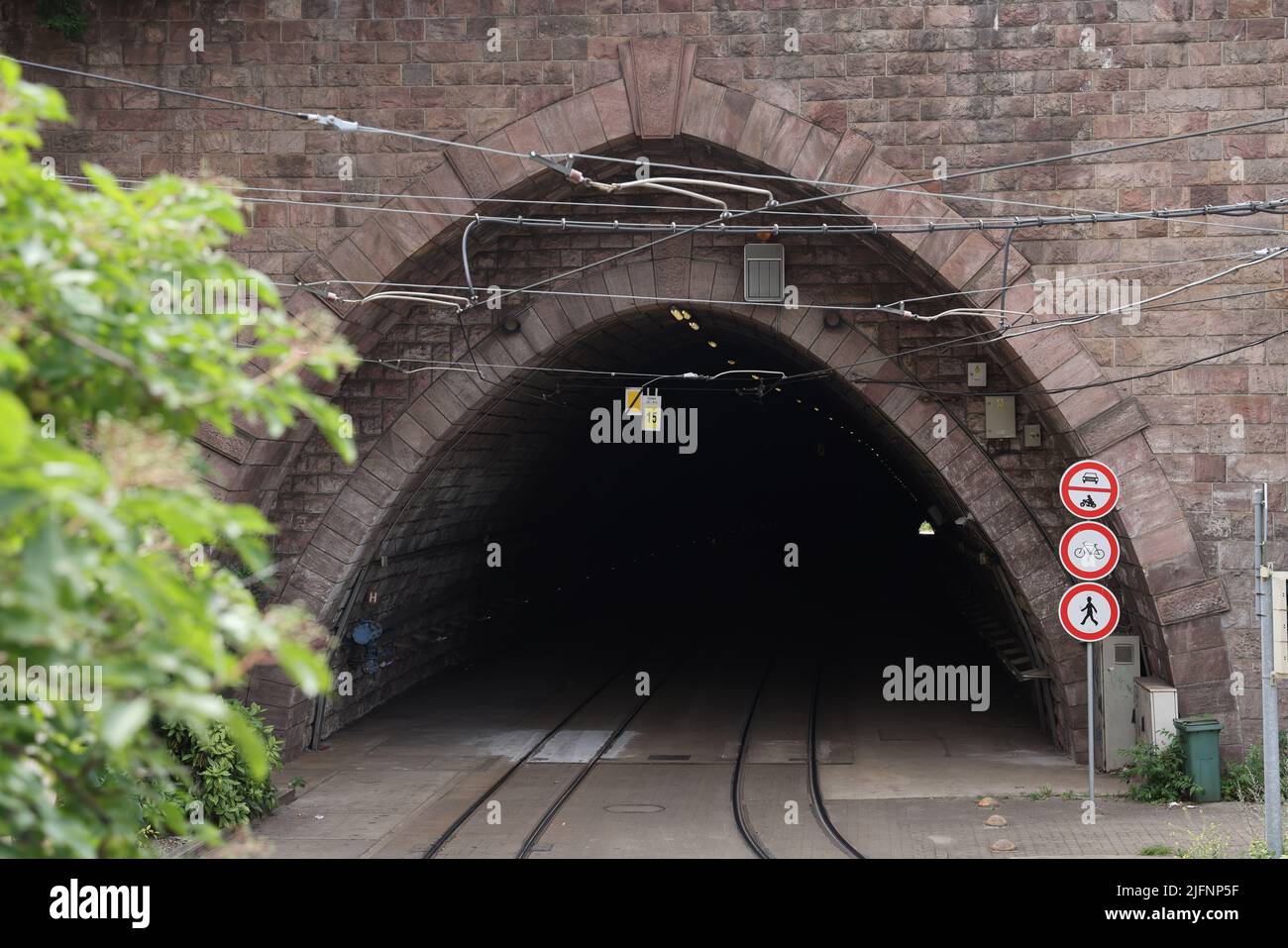 Tunnel entrance with traffic signs indicating entrance is forbidden for ...