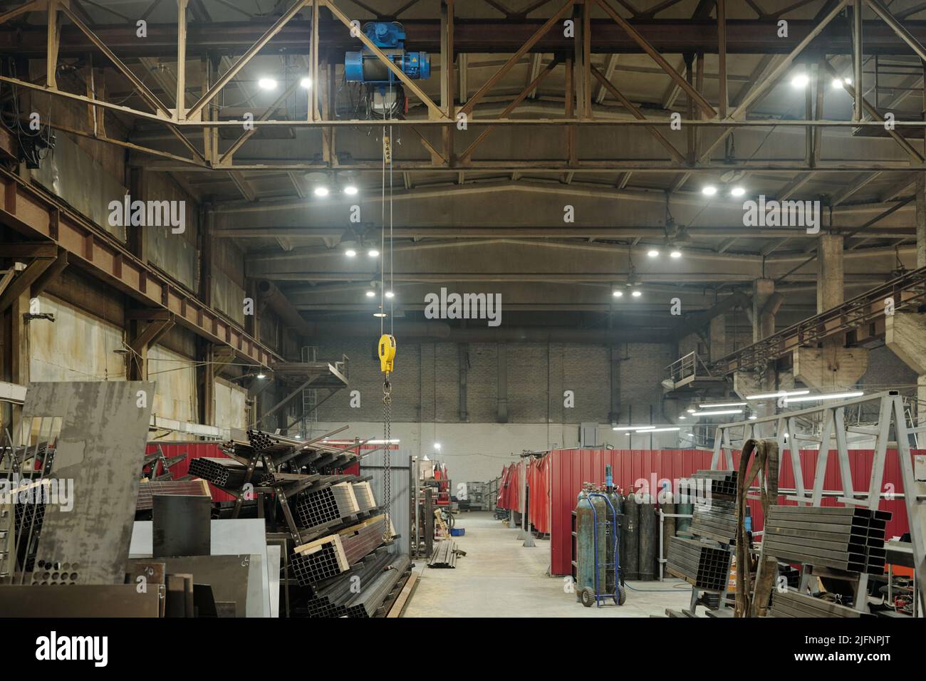 Interior of spacious workshop with construction materials for ...