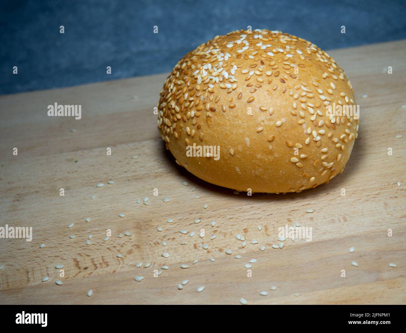 Bakery products. Table in the bakery. White bun on a cutting board ...