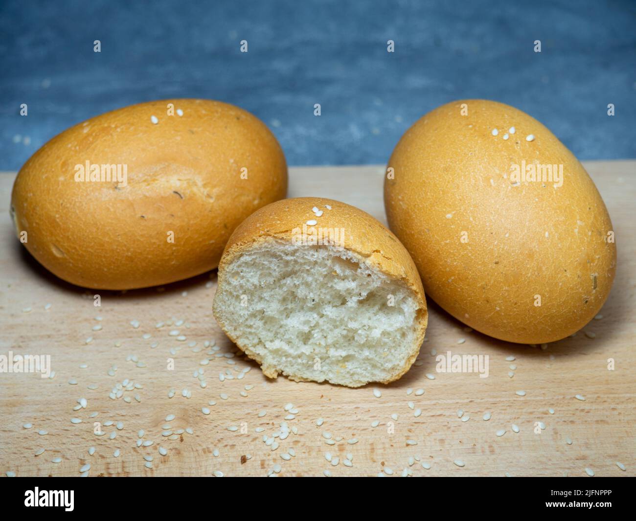 Bakery products. Table in the bakery. White bun on a cutting board ...