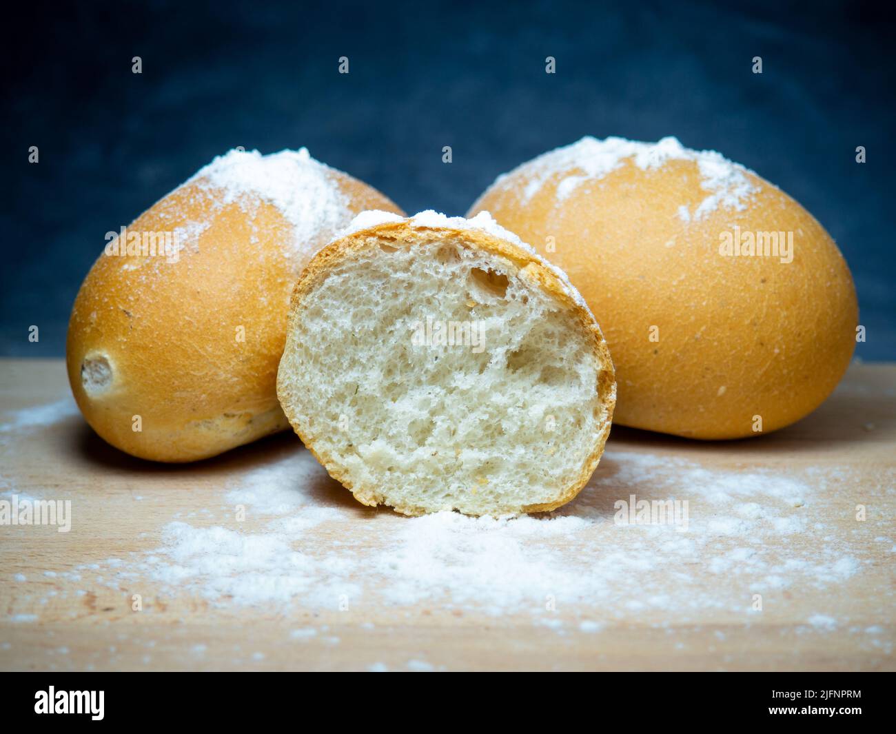 Bakery products. Table in the bakery. White bun on a cutting board ...