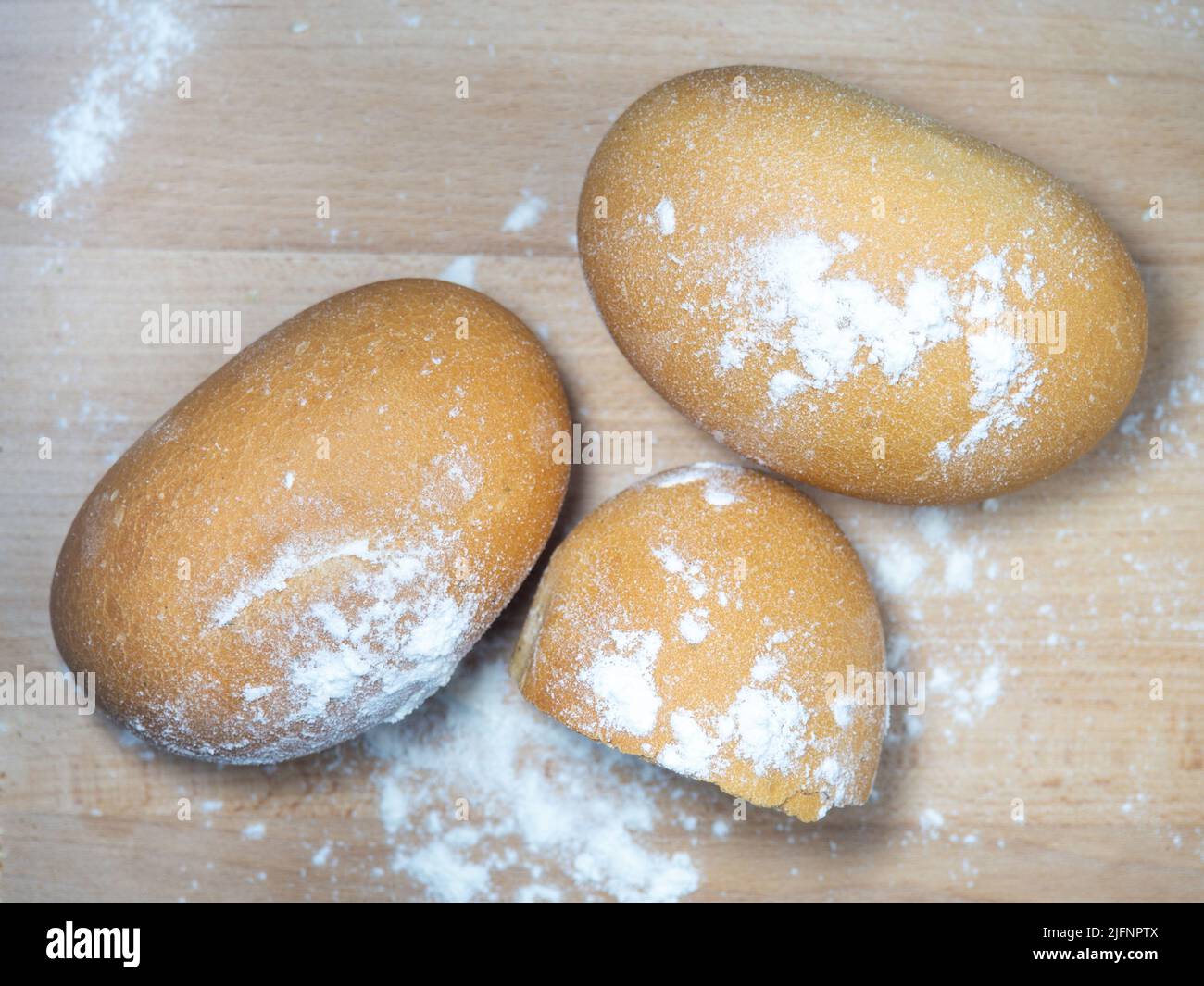 Bakery products. Table in the bakery. White bun on a cutting board ...