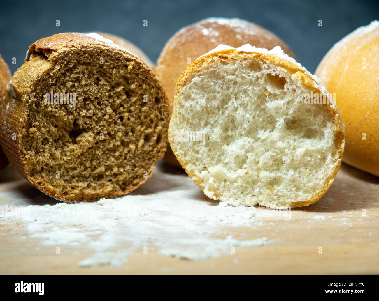 Bakery products. Table in the bakery. Buns on a cutting board. Rye and ...