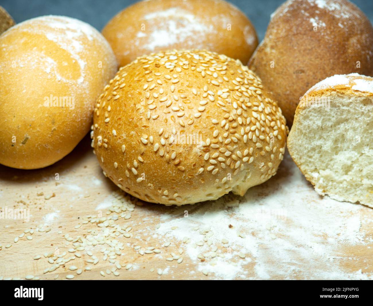 Bakery products. Table in the bakery. Buns on a cutting board. Rye and ...