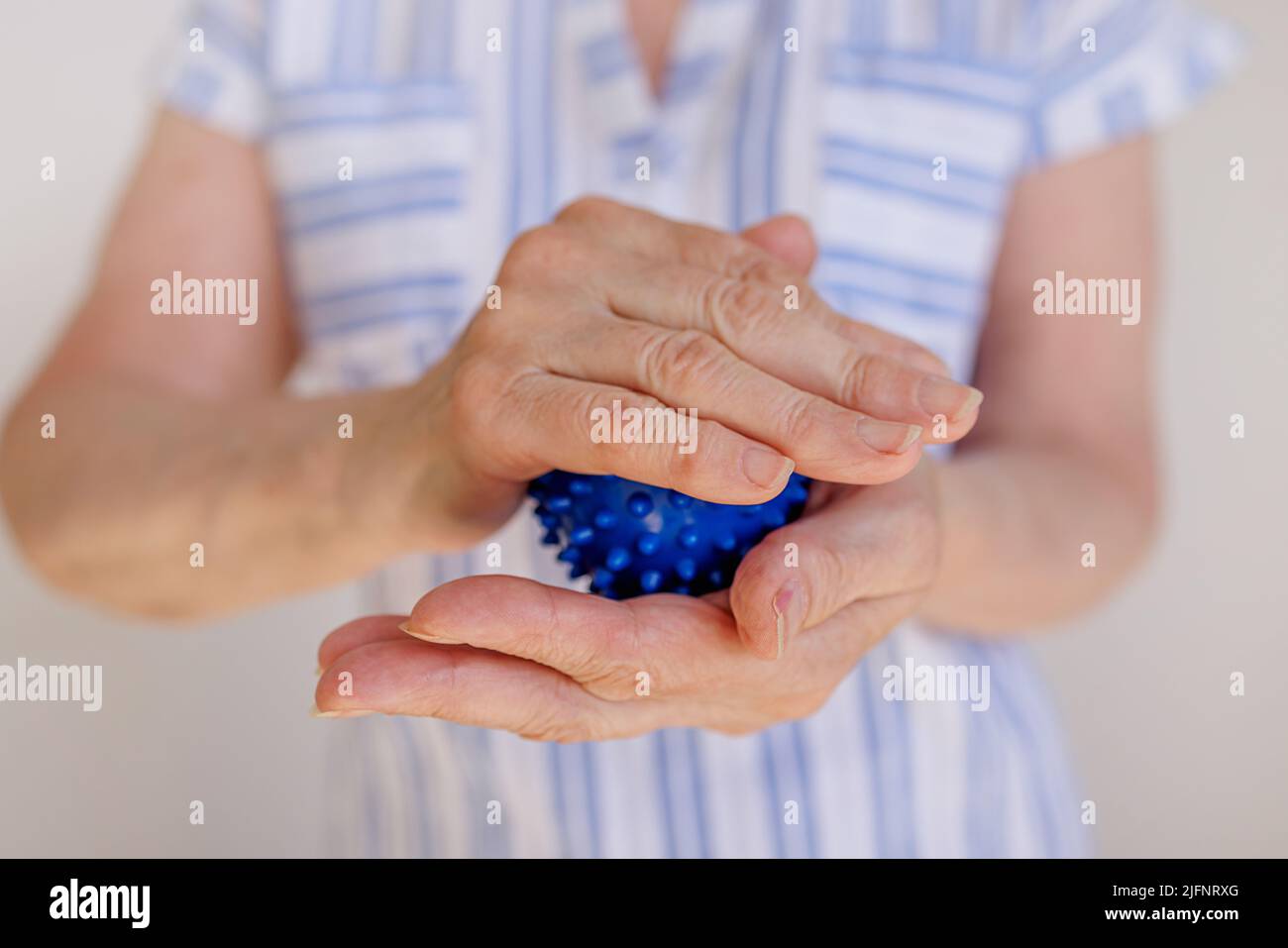 Self-massage technique with a prickly ball for hand diseases, arthritis ...