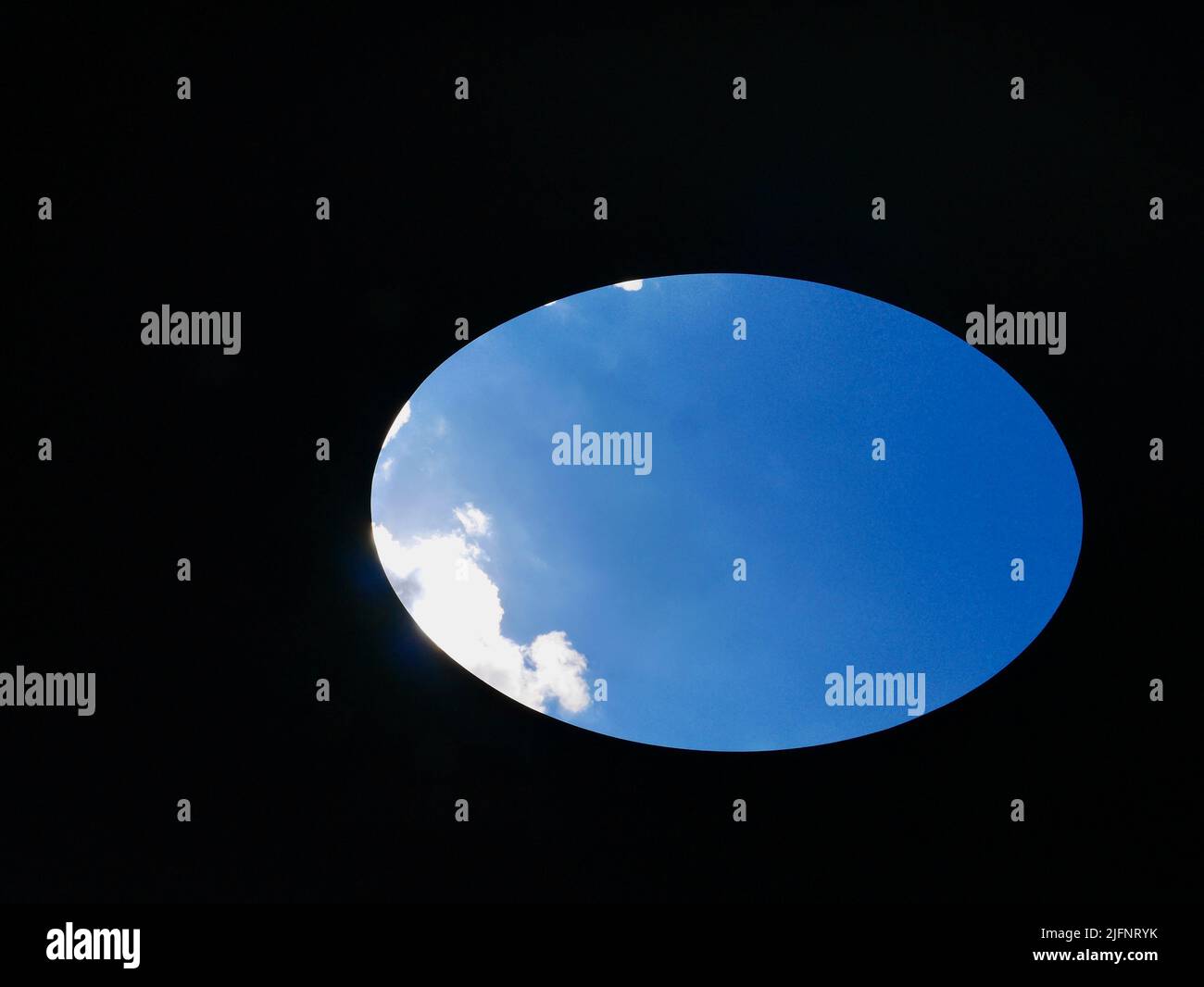 Blue sky with clouds seen through oval hole Stock Photo - Alamy Blue sky with clouds seen through oval hole Stock Photo - Alamy