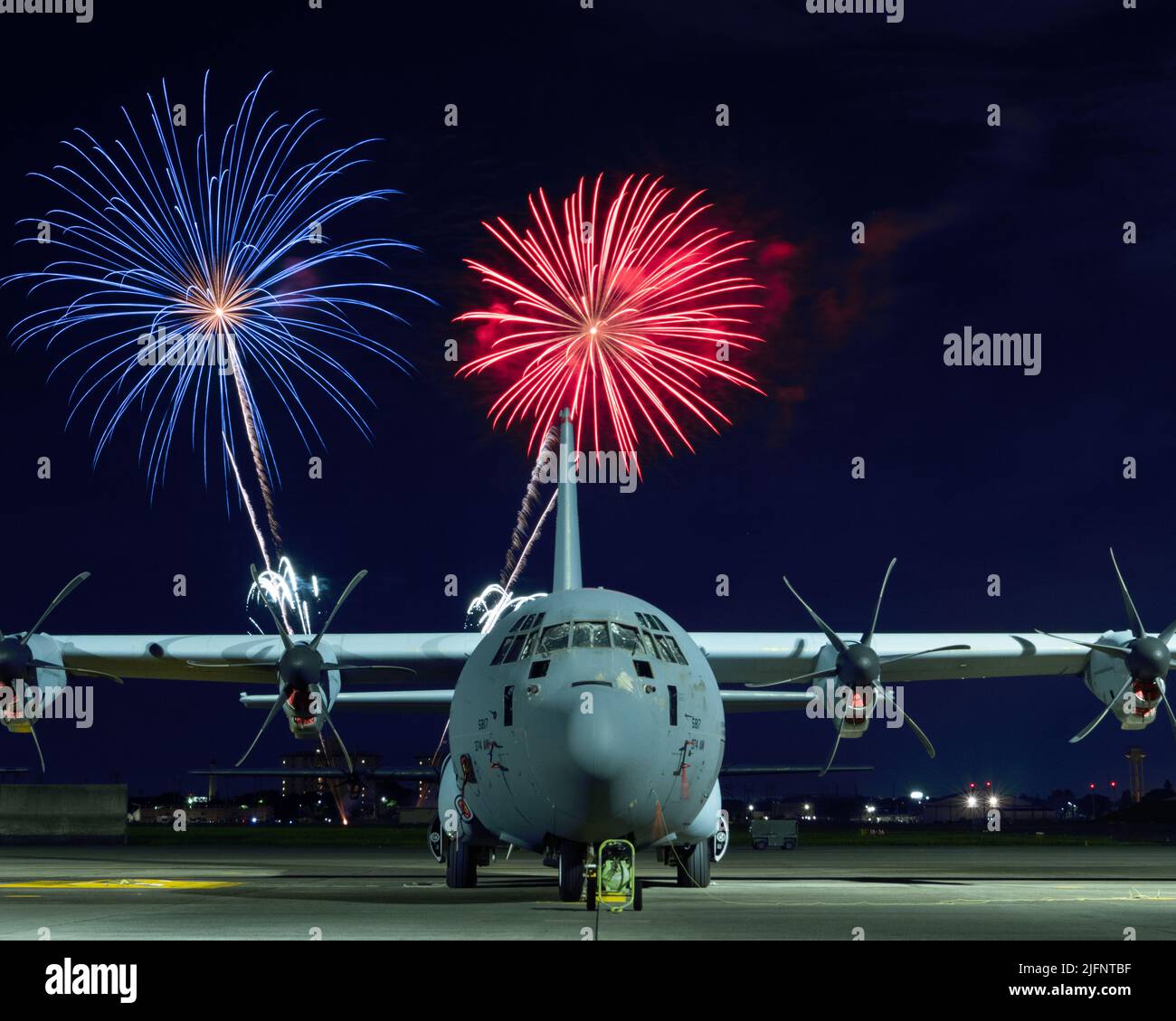 Fireworks explode behind a C-130J Super Hercules at Yokota Air Base, Japan, July 4, 2022. The ...