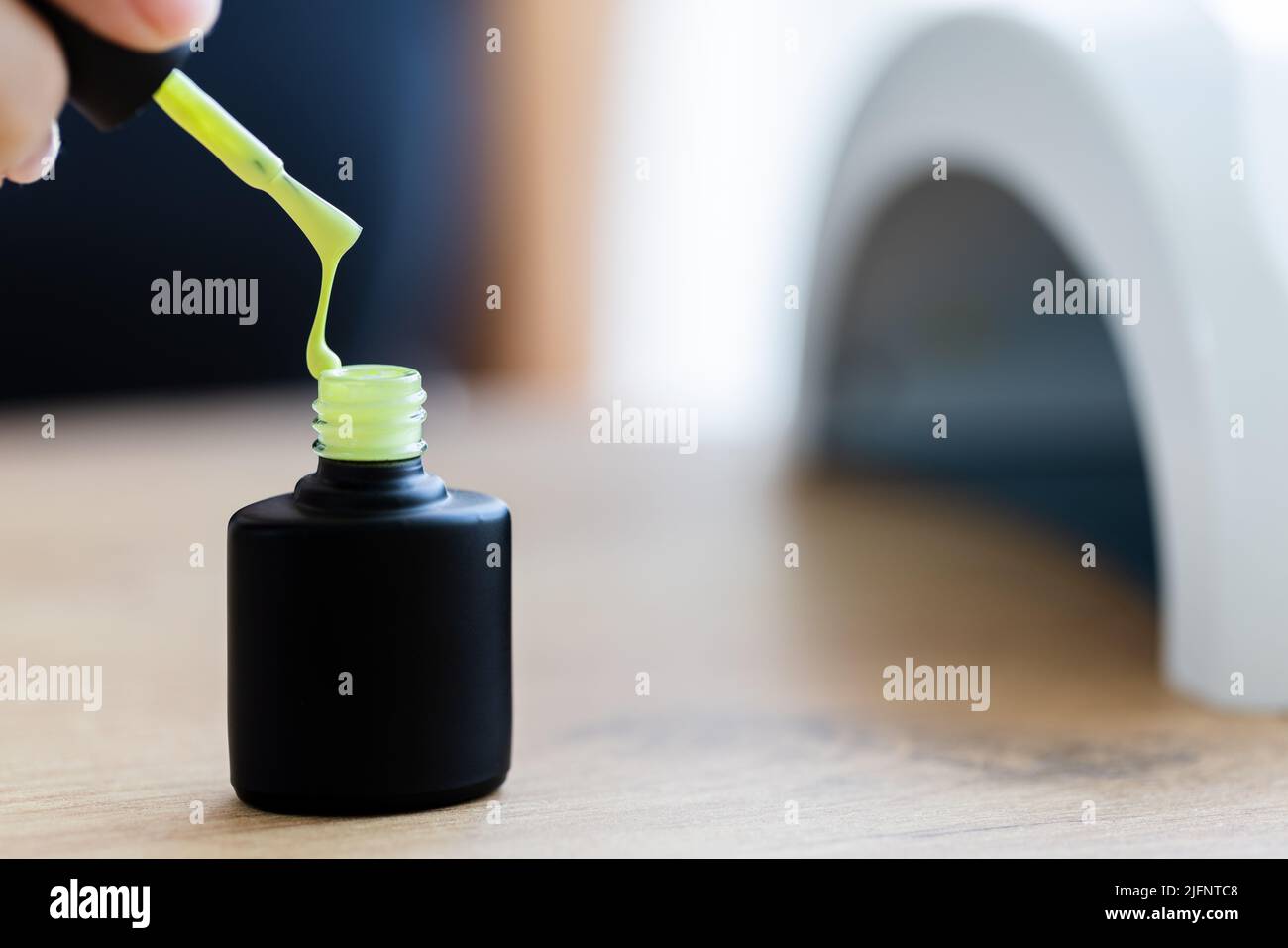 Bottle of shellac with light green color. Summer color for nails Stock ...