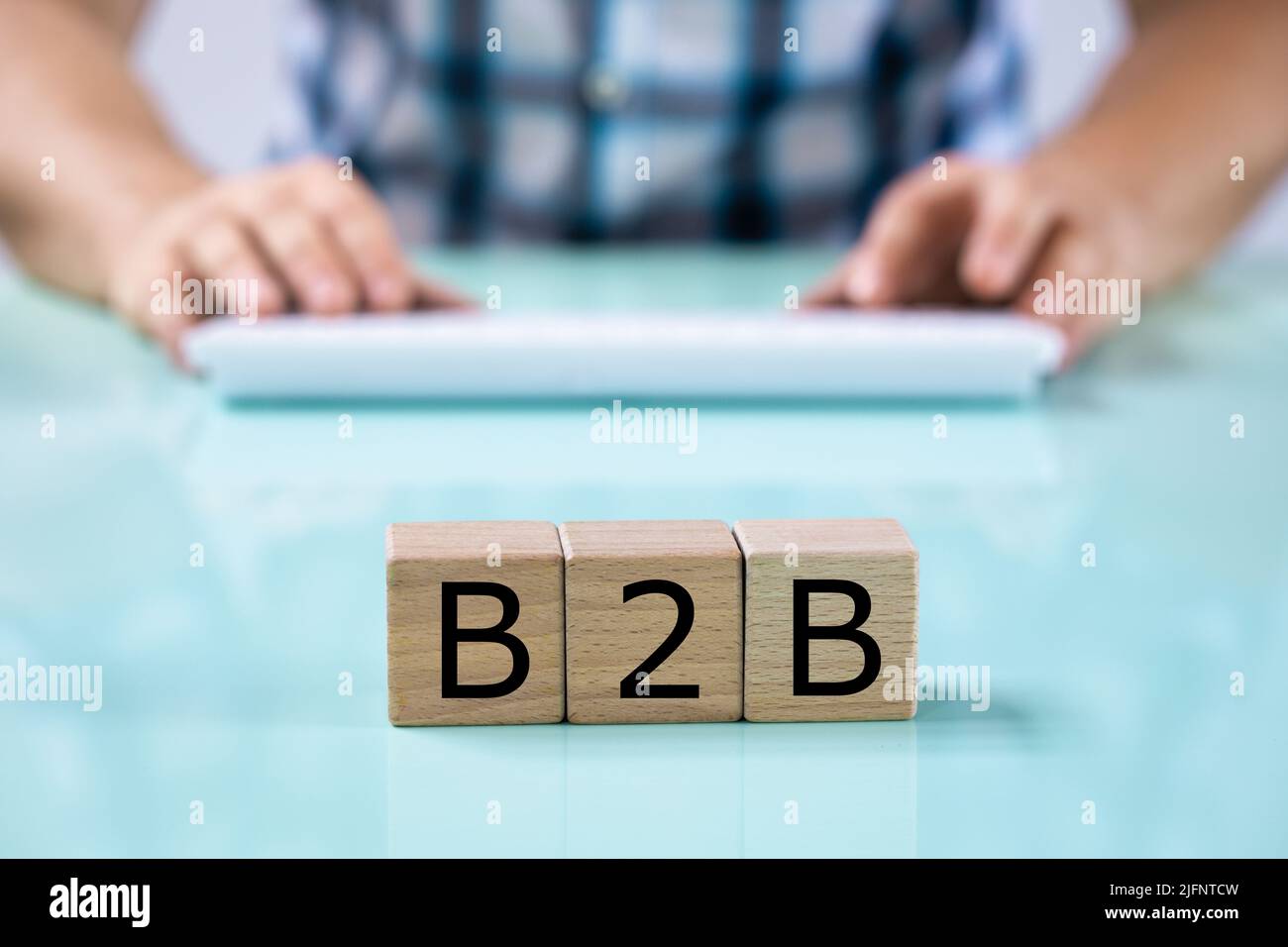 B2B, business to business, text on wooden blocks, man behind the ...