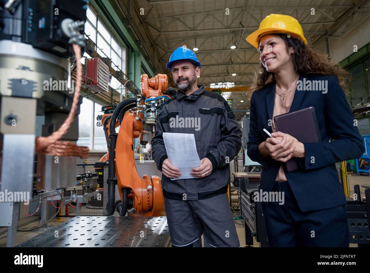 Female engineering manager and mechanic worker doing routine check up ...