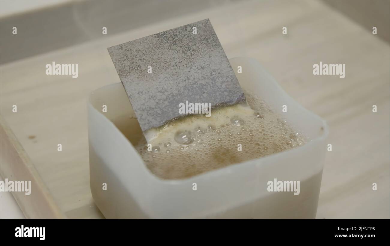 Chemical inspection of plate. Clip. Bubbling chemical liquid with metal ...