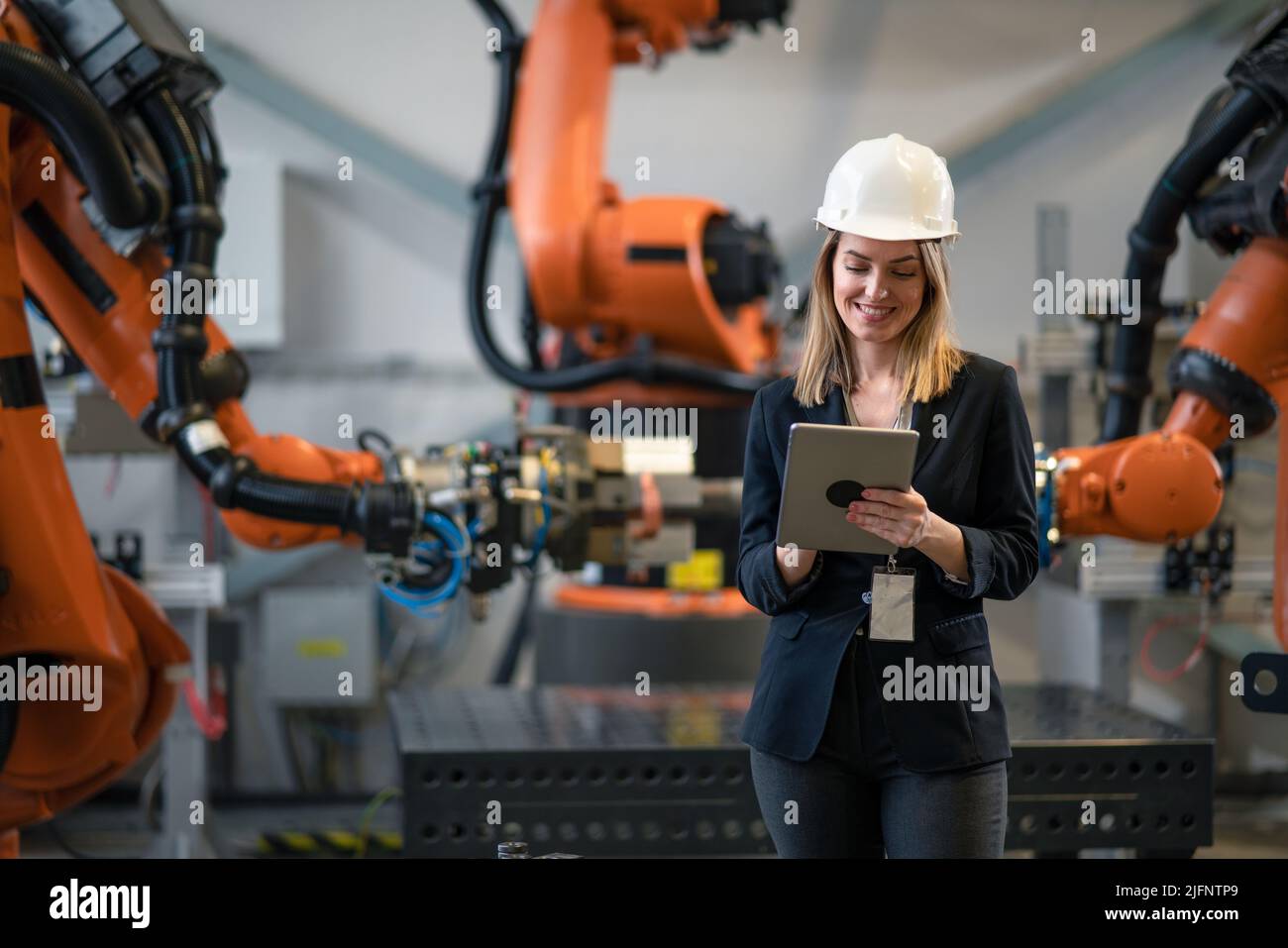 Portrait of female chief engineer in modern industrial factory using ...