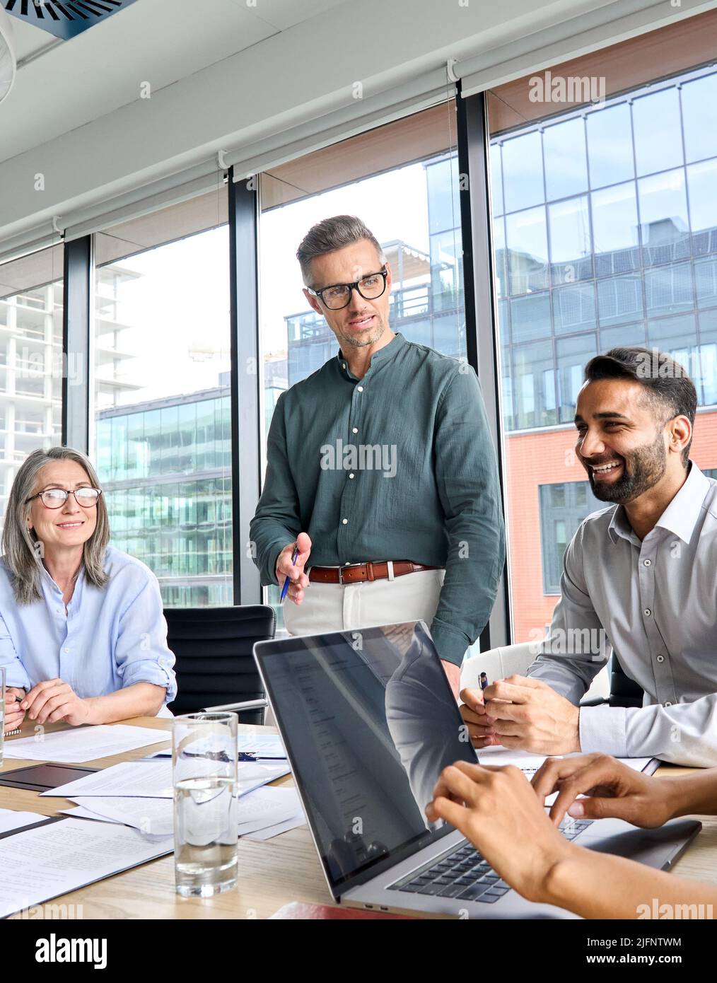 Ceo male leader talking to partners at meeting in boardroom in modern ...