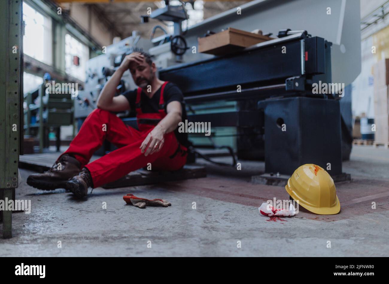 Worker suffering from pain after accident in factory. First aid support ...