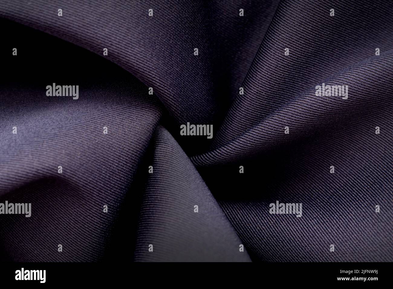 A twisted piece of dark blue material. Fabric for tailoring Stock Photo ...