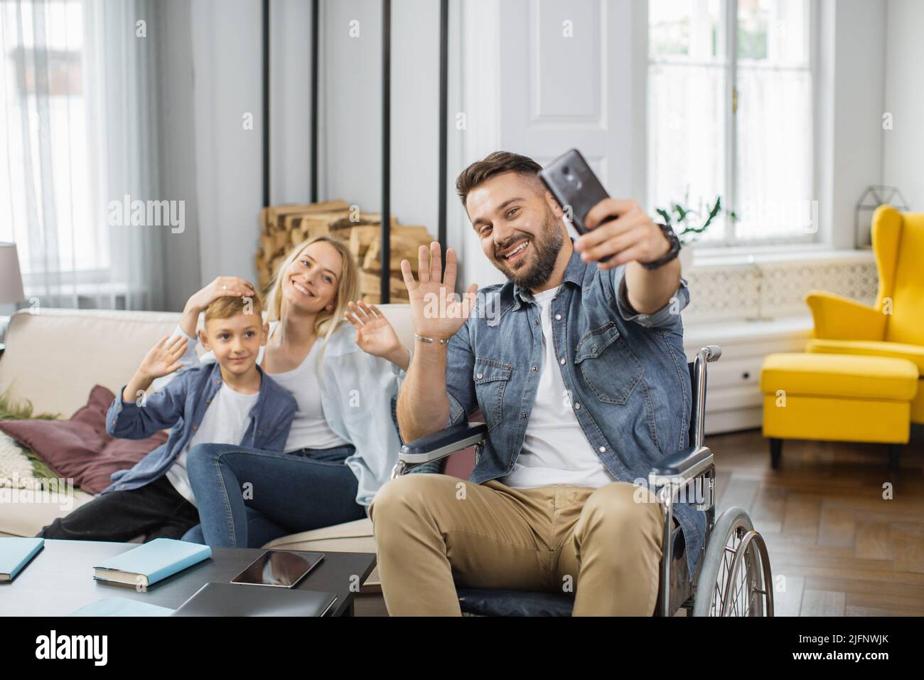 Caucasian man with disabilities holding smartphone and taking selfie ...