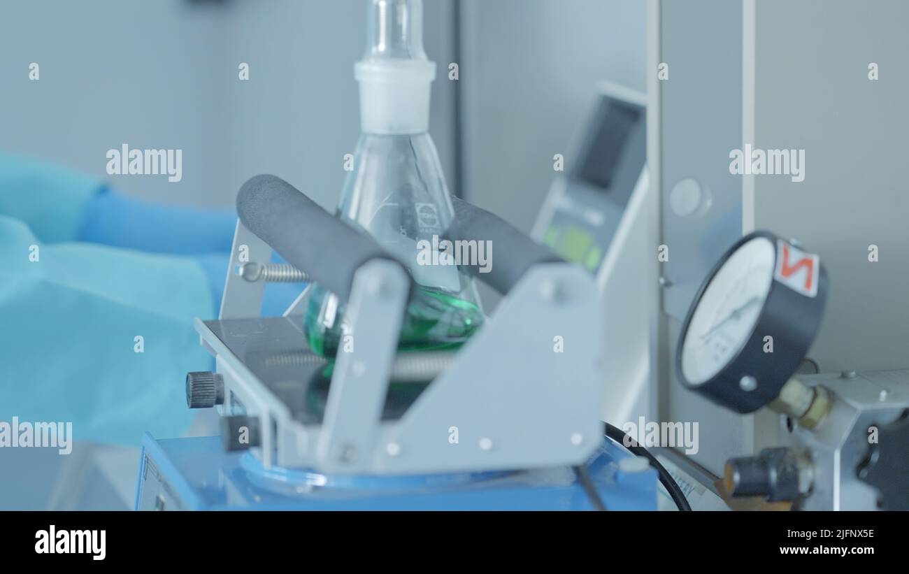 Shaker for mixing solutions, liquid substance is being mixed by a ...