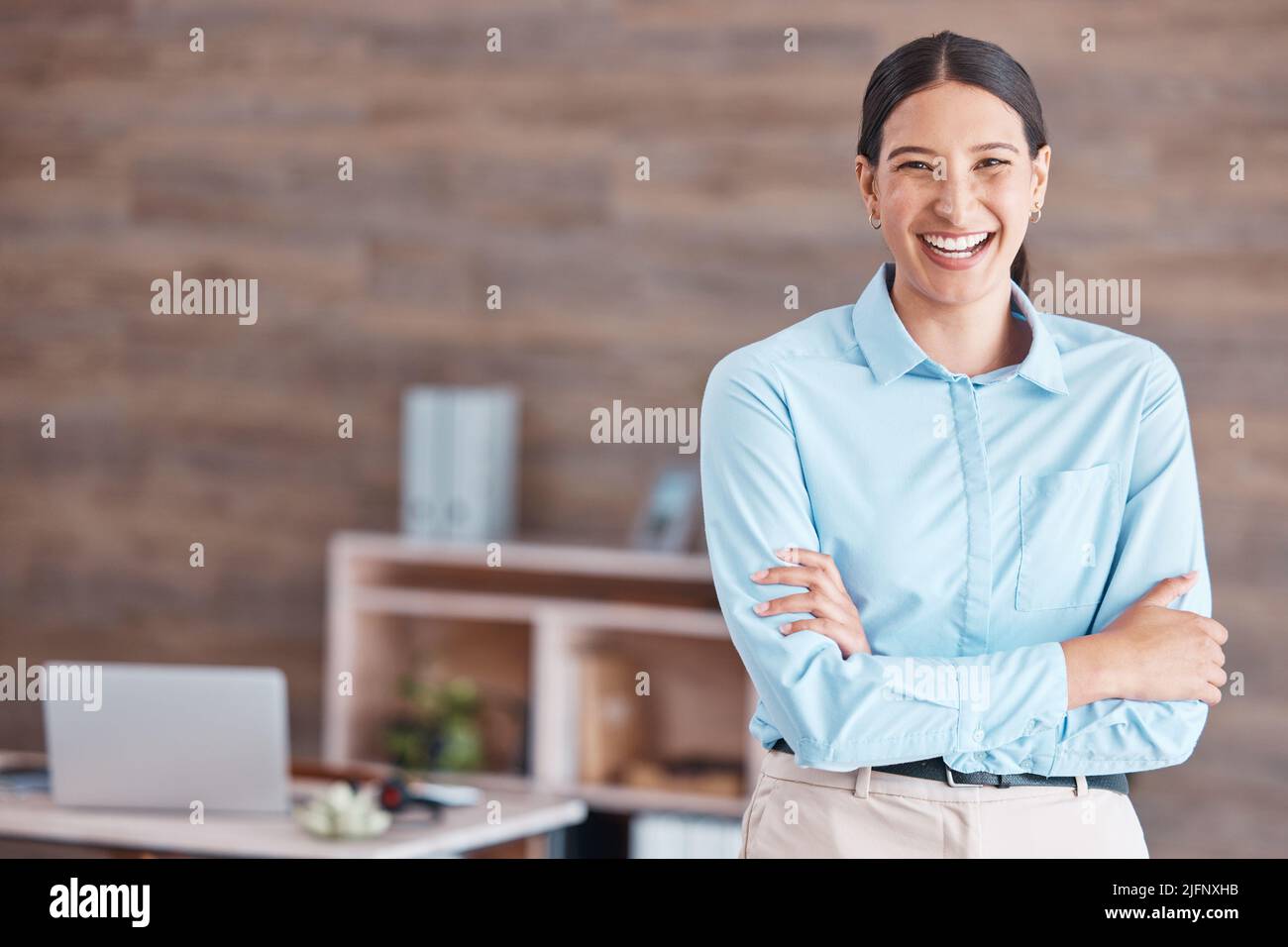 Young happy cheerful mixed race businesswoman smiling while standing ...