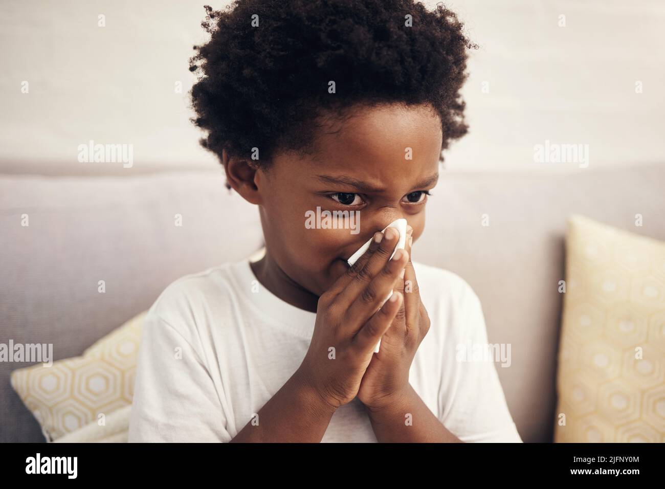 Cold and flu season. Sick african american boy with afro blowing nose ...