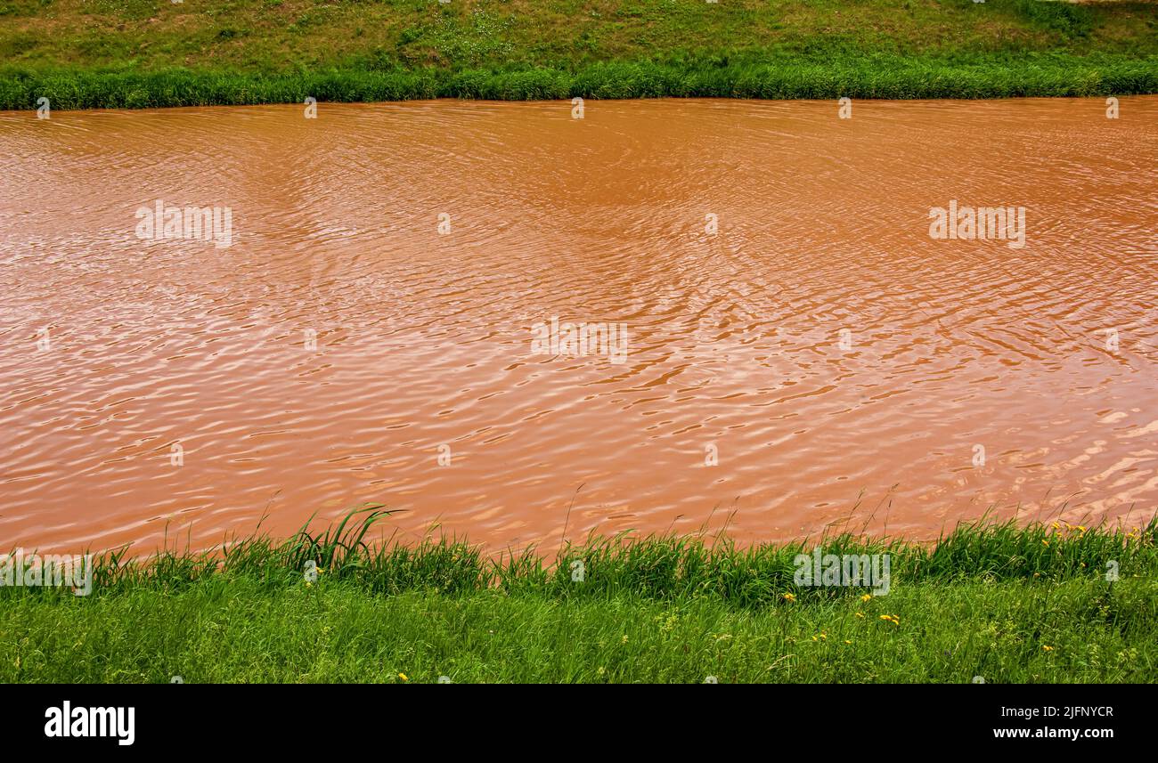 The water surface of the river is orange. Light brown river background ...