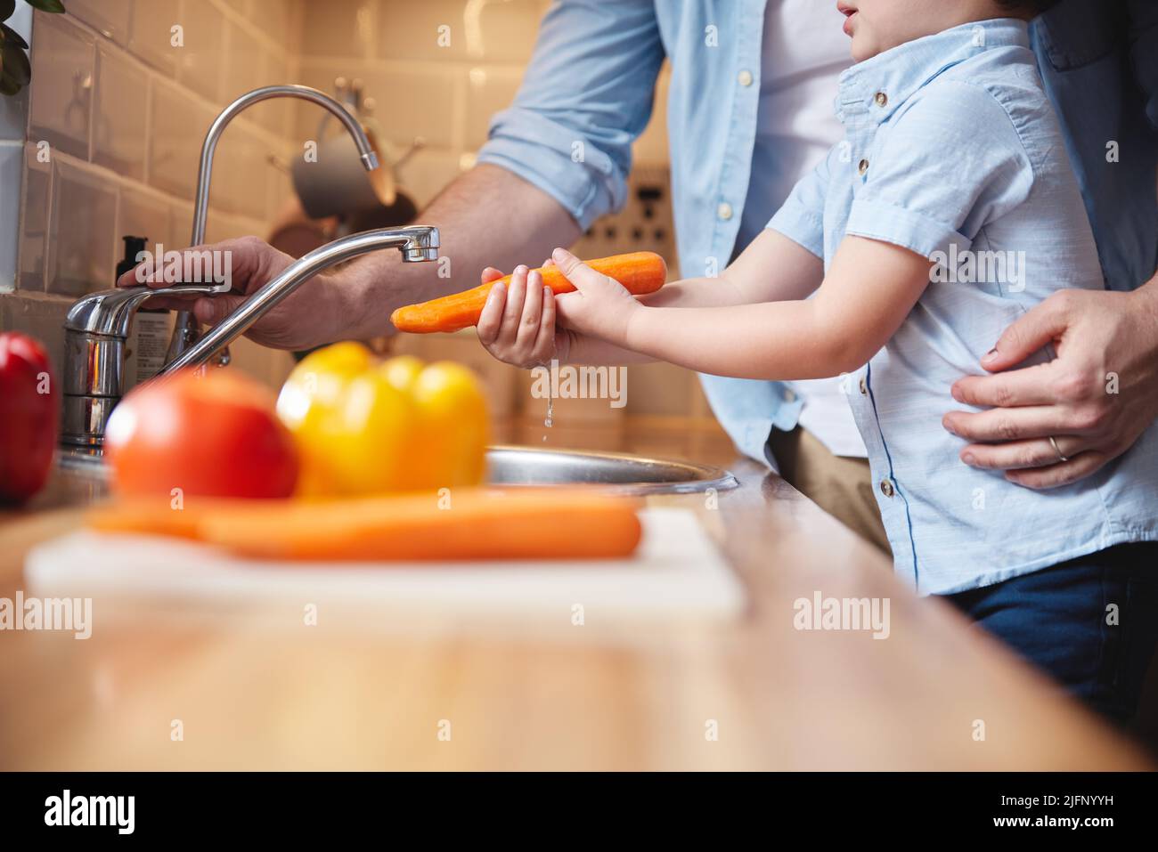 We rinse our vegetable before using it, like we should. Shot of a young ...