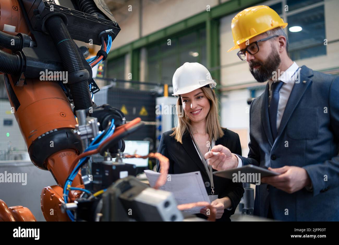 Chief engineer and project manager in modern industrial factory with ...