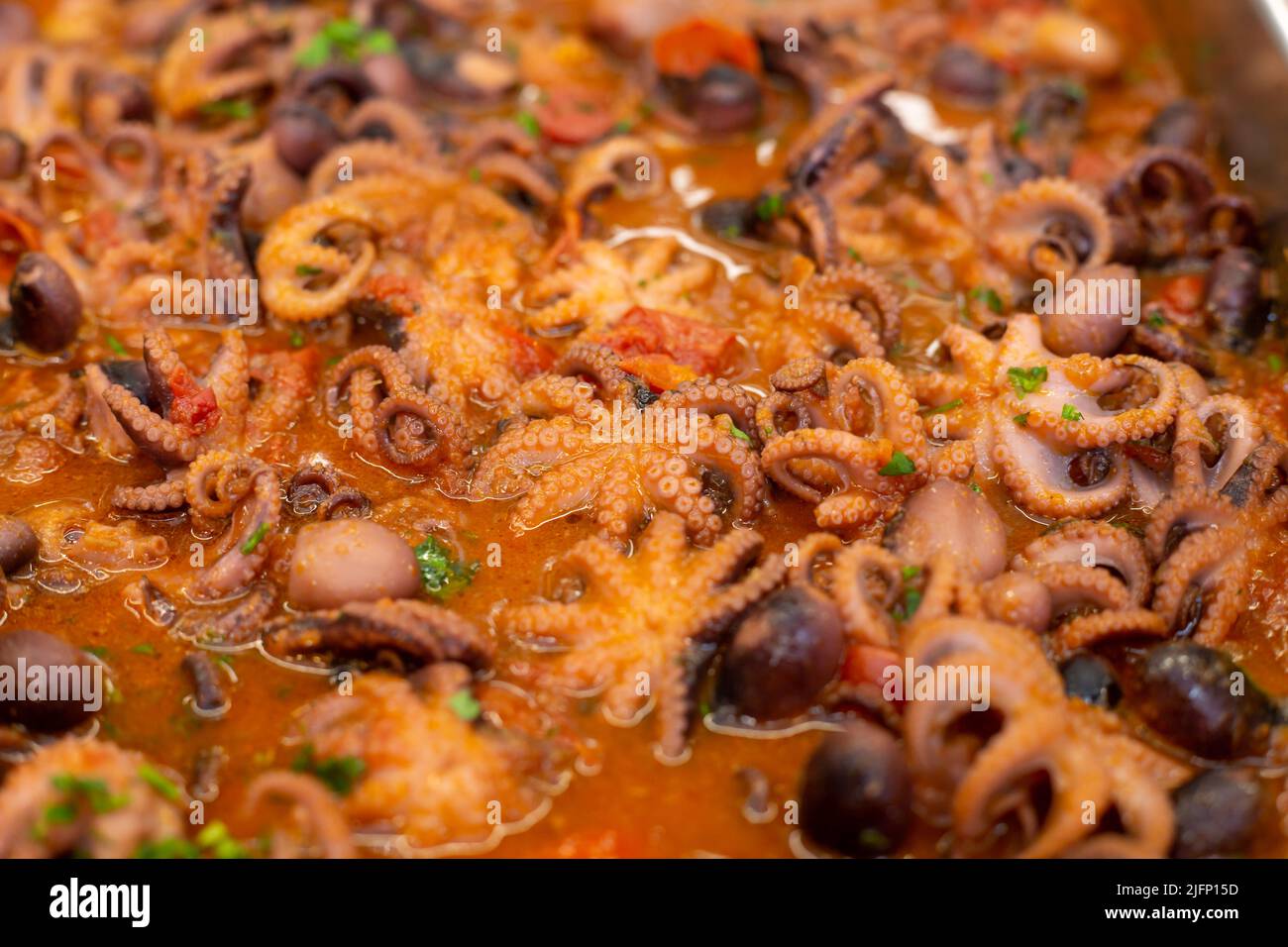 Octopuses are cooked with tomato, olives.Octopus Guazzetto,octopus ...
