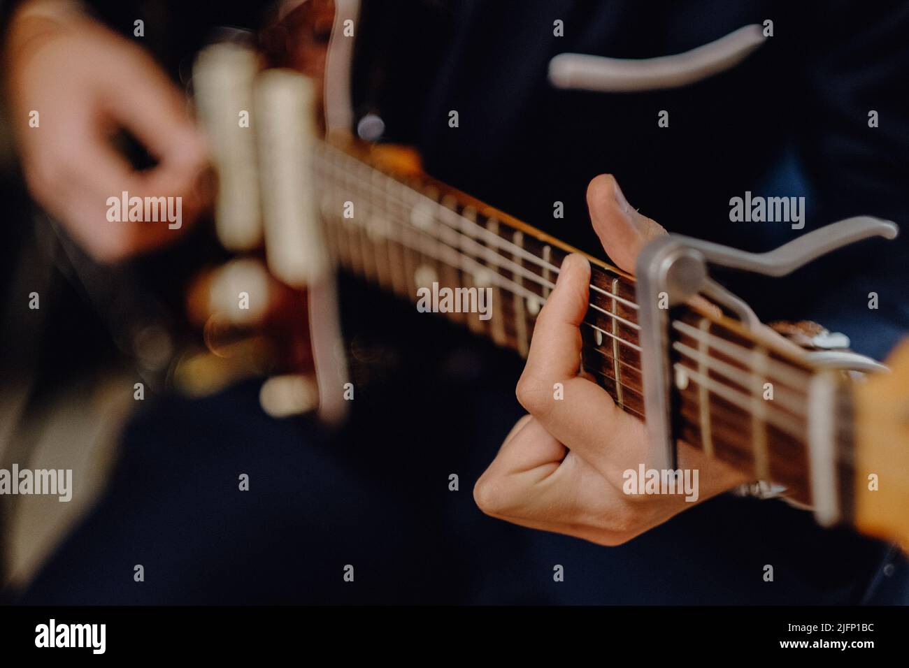 A shallow focus shot of a person playing an electric guitar Stock Photo ...