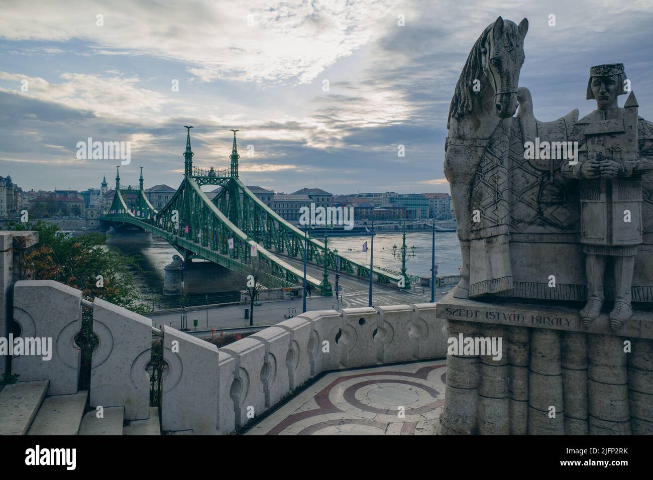 A shot of dawn at Liberty Bridge from the Gellert Hill Cave Stock Photo ...
