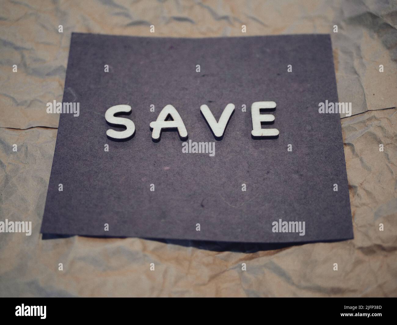 Save in wooden lettering. Perfect graphic to illustrate saving in a ...