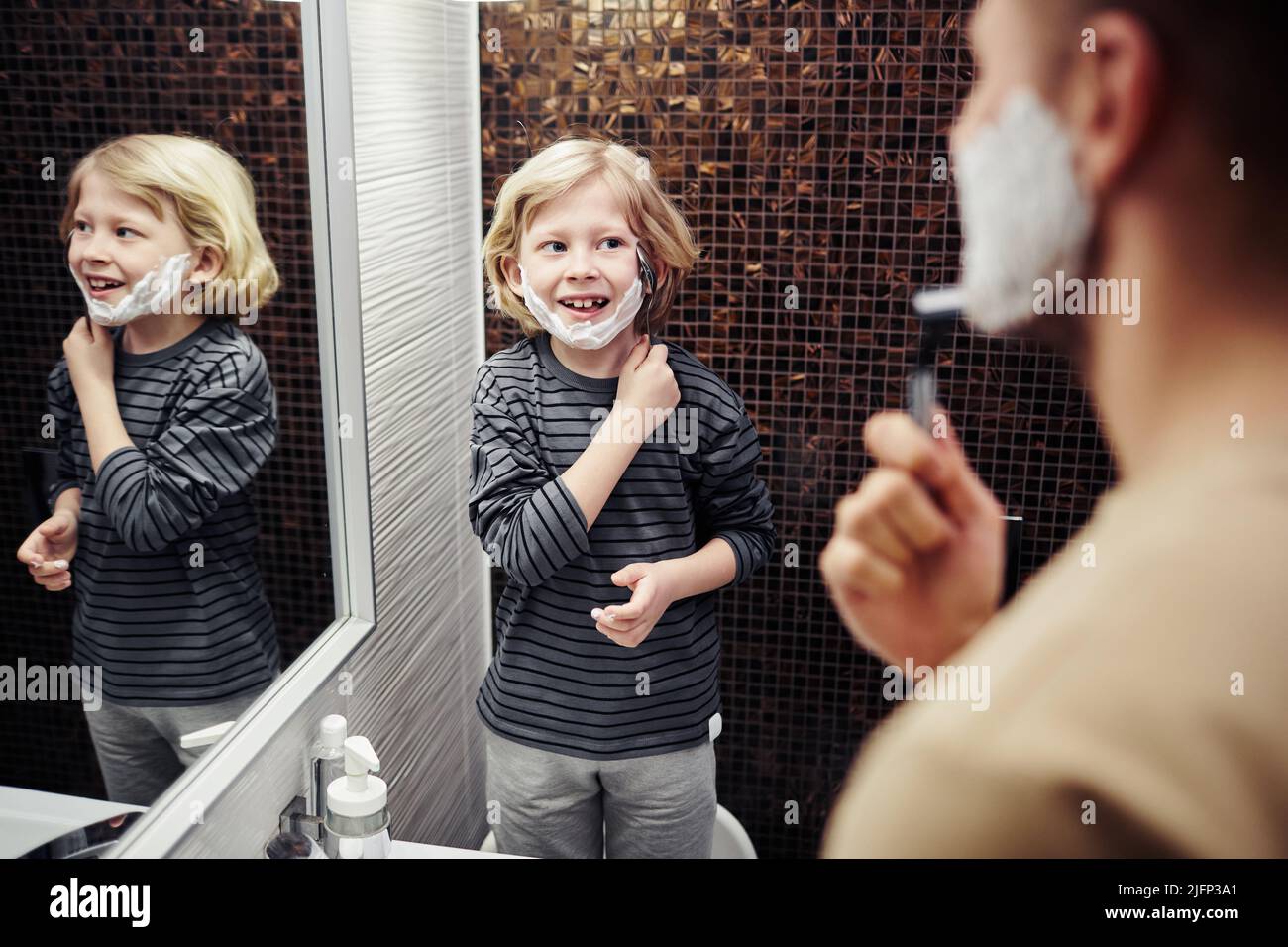 Boy imitating father shaving hi-res stock photography and images - Alamy