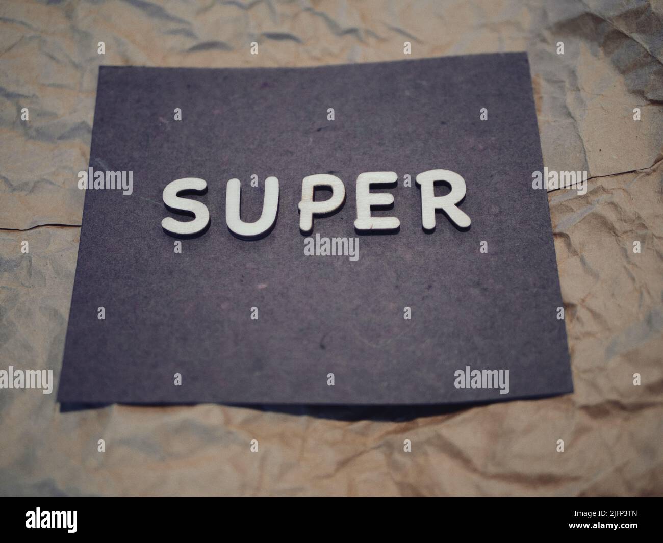 Super in wooden lettering. Perfect to illustrate something positive ...